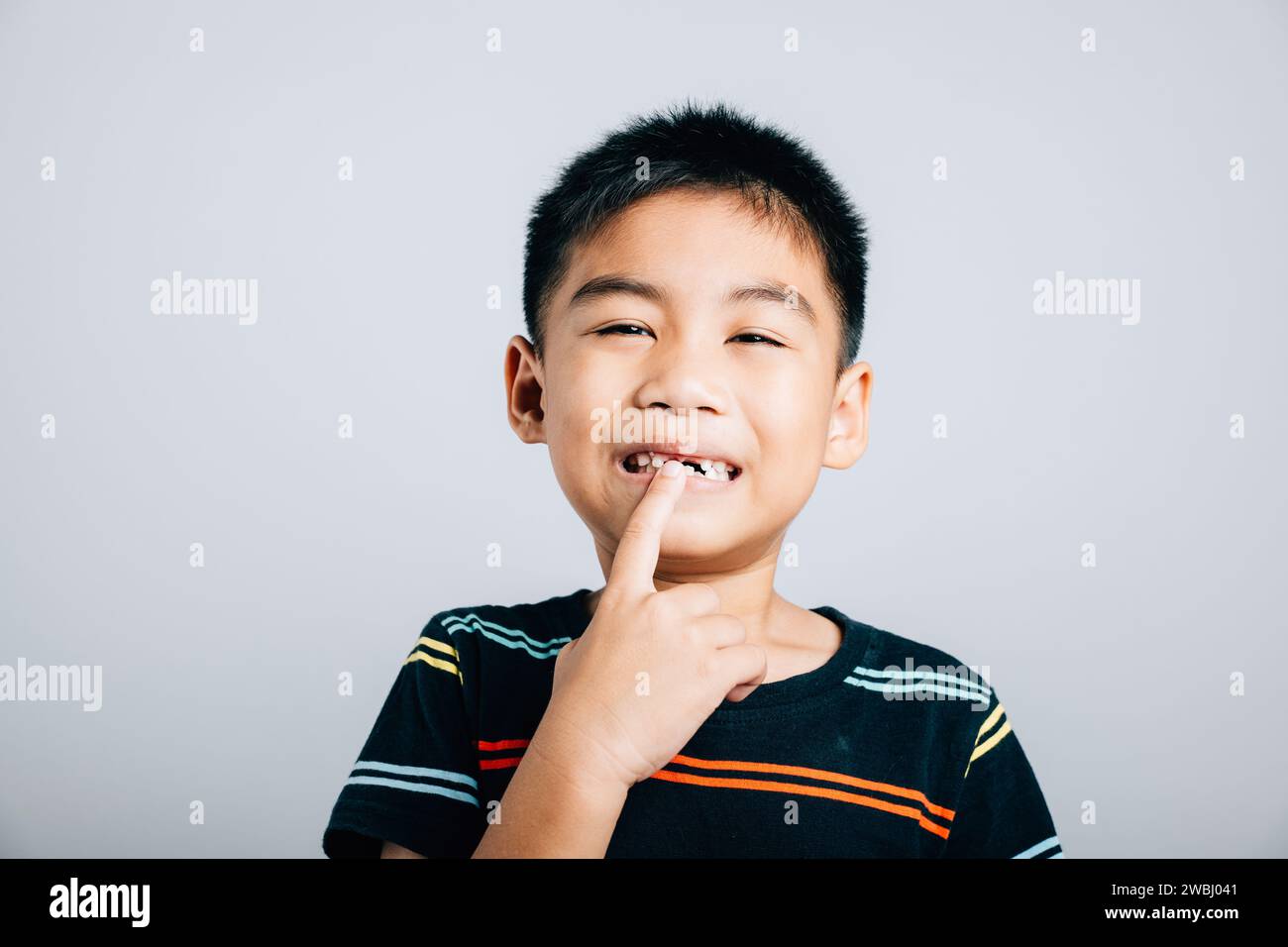 Cute boy widely smiling points to growing molar gap. joyful portrait ...
