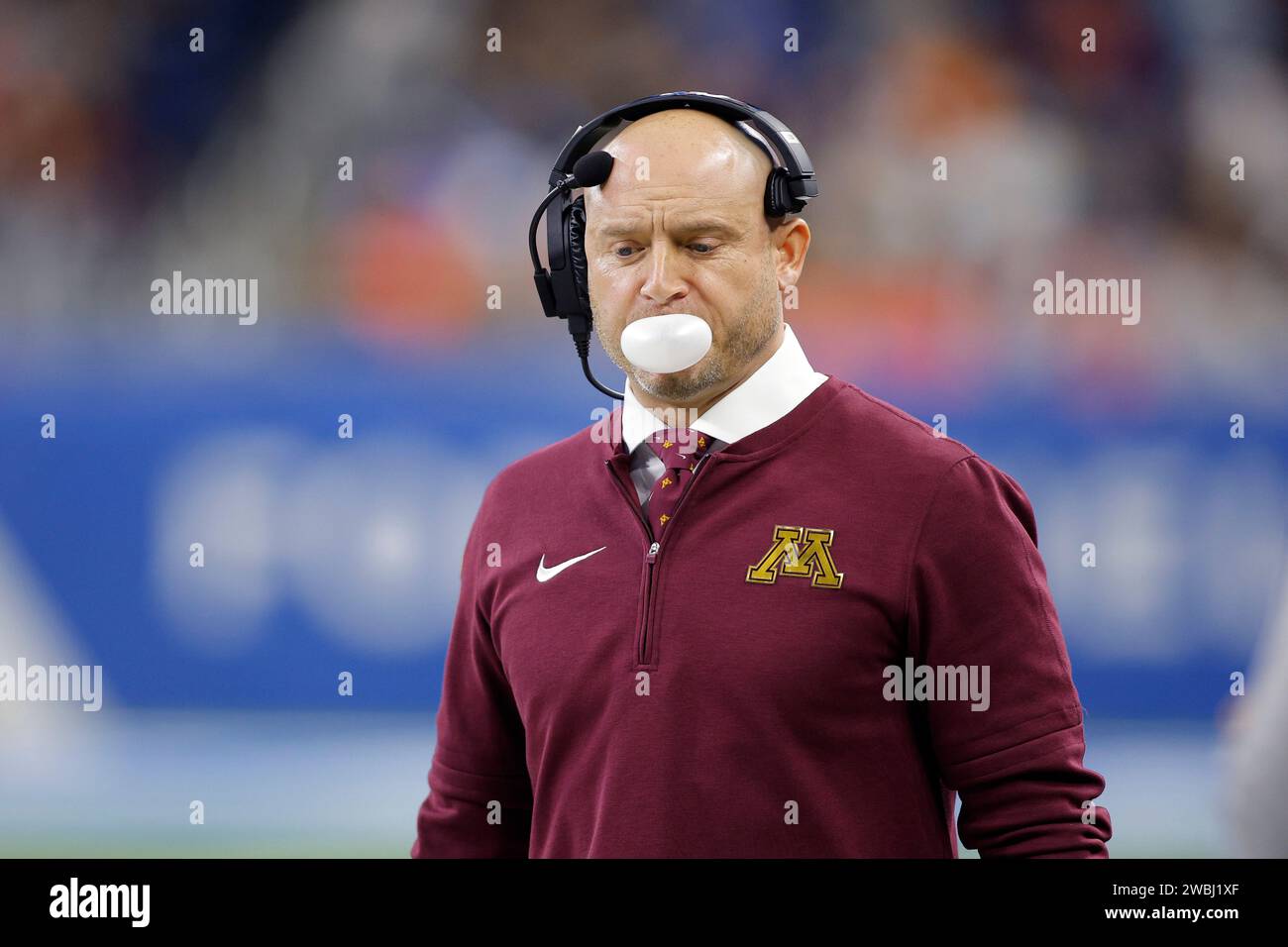 Minnesota coach P.J. Fleck blows a bubble as he walks the sideline ...