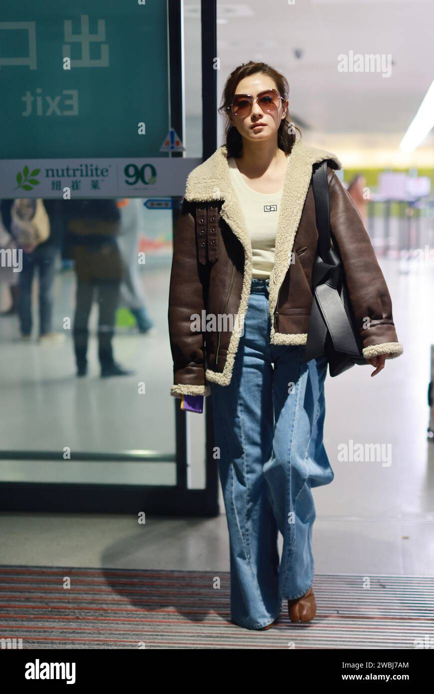 Chinese actress and singer Wan Qian appears at the airport in Shanghai ...