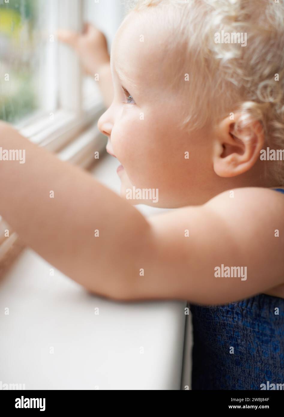 Girl, window and baby with smile standing against glass or wall in ...