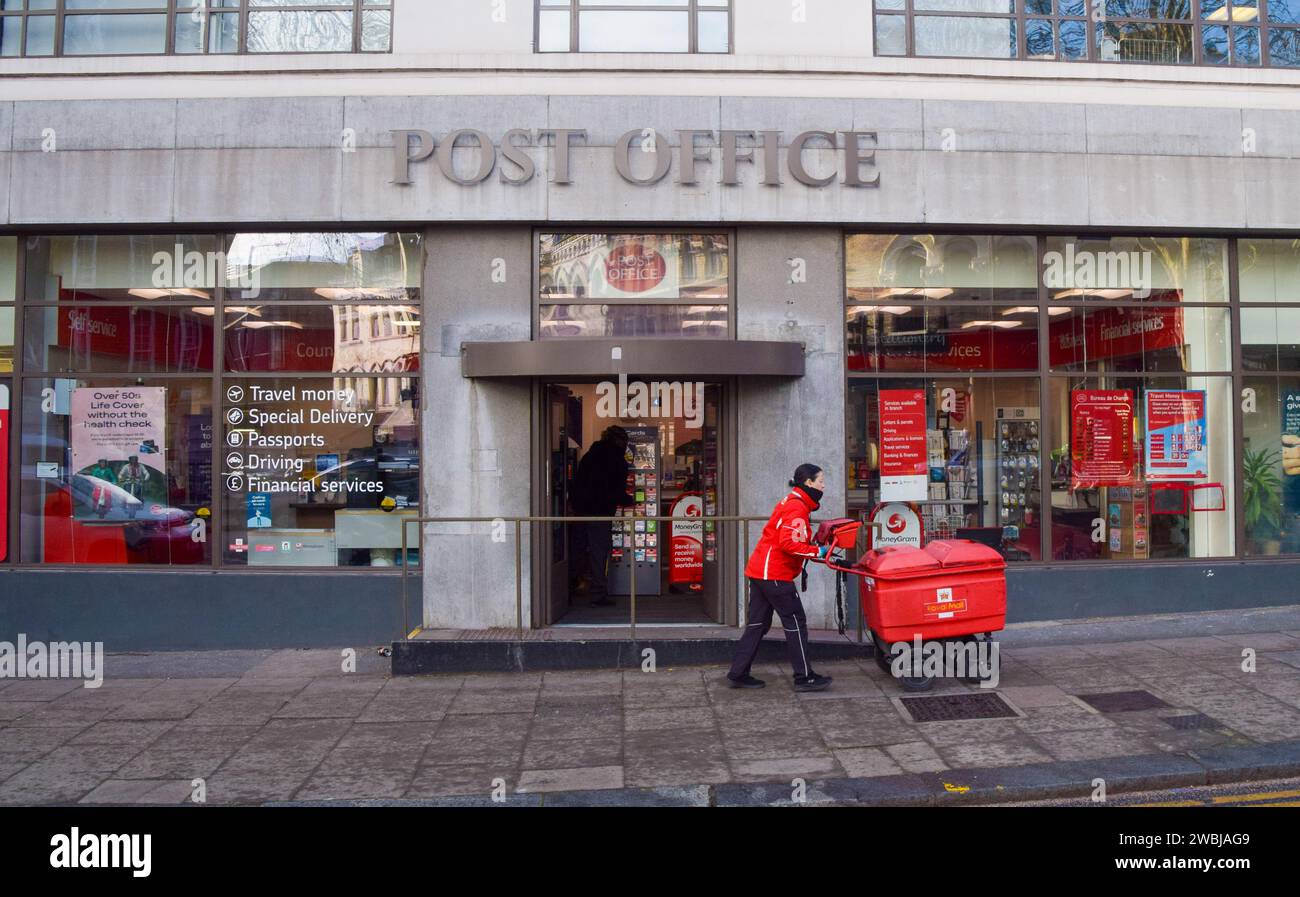 London, England, Uk. 11th Jan, 2024. A postal worker passes by the ...