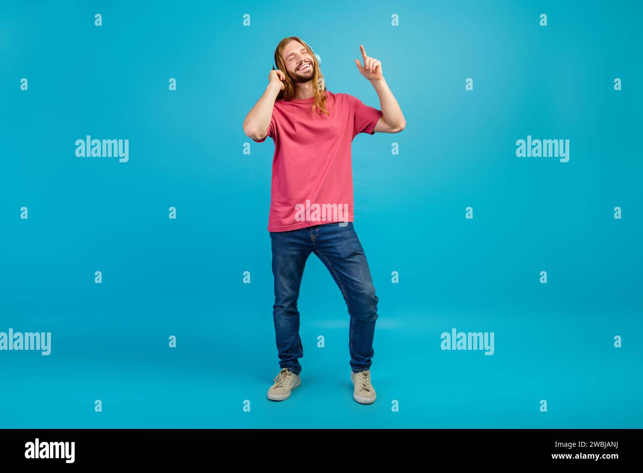 Full size portrait of overjoyed nice person hand touch headphones point ...