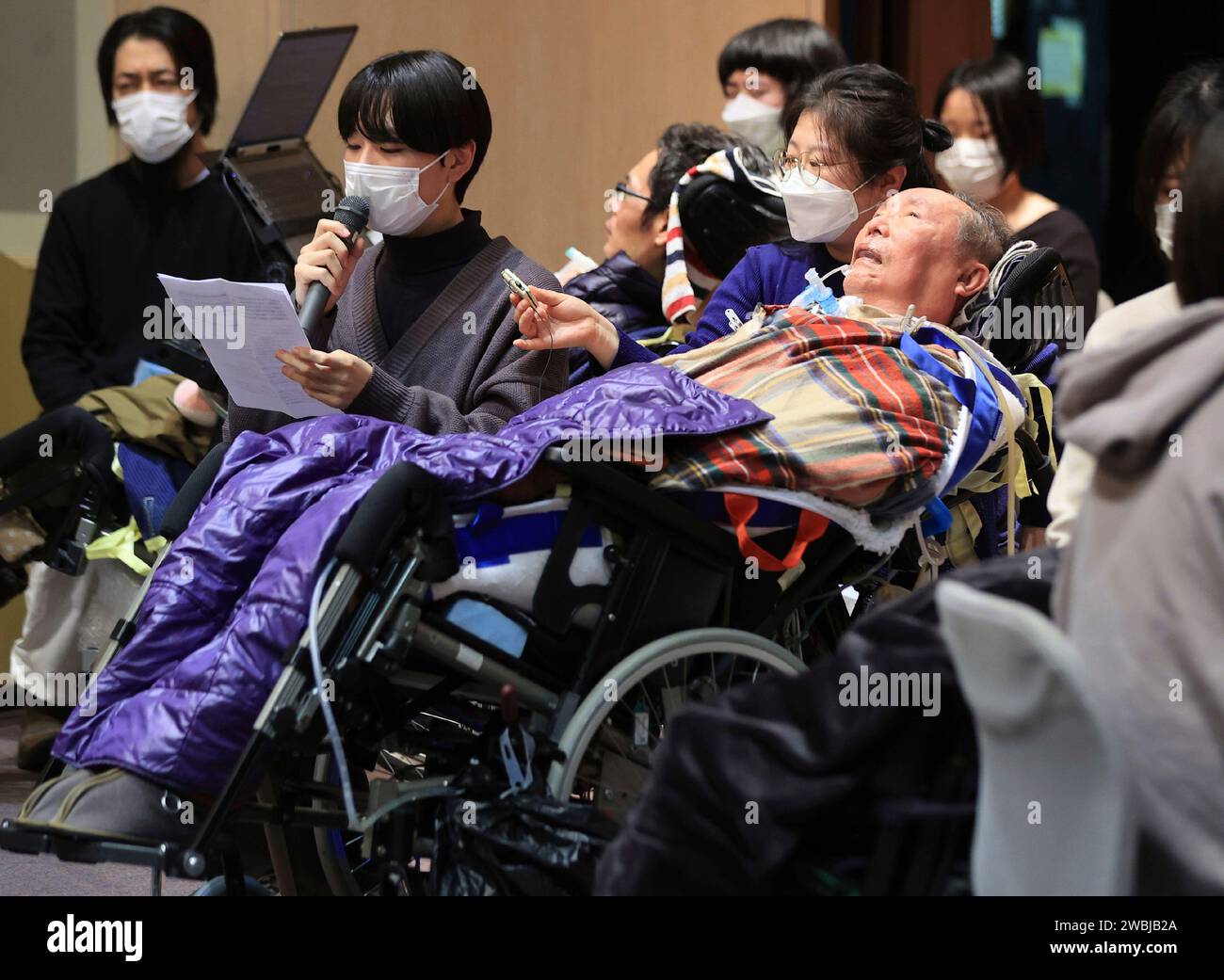 Hideaki Masuda, a consultant for the Japan ALS Association, lets his ...