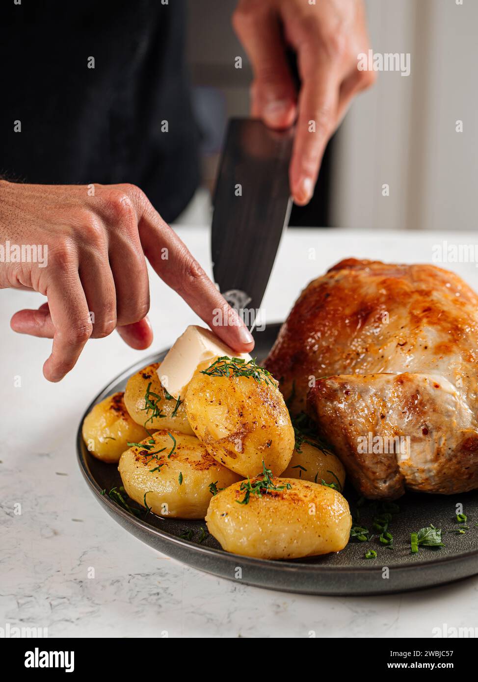 Chef preparing baked chicken with potatoes Stock Photo - Alamy
