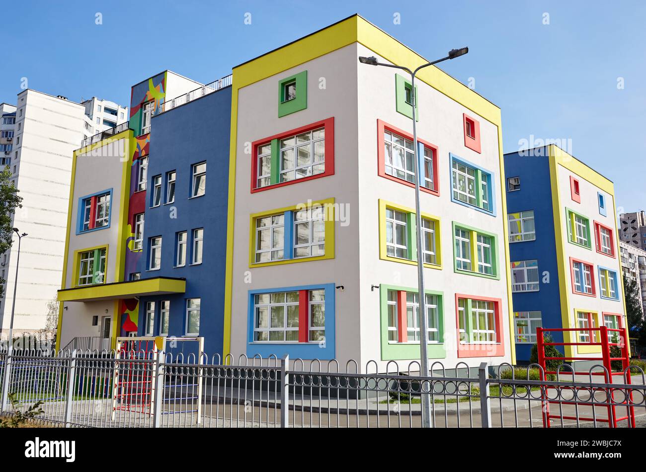 Facade of kindergarten building. Colorful playground for childrens on a ...
