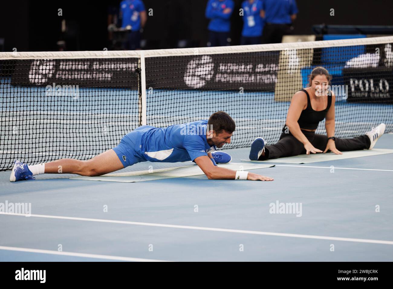 January 11, 2024: Novak Djokovic attempts a middle stretch with gymnast ...