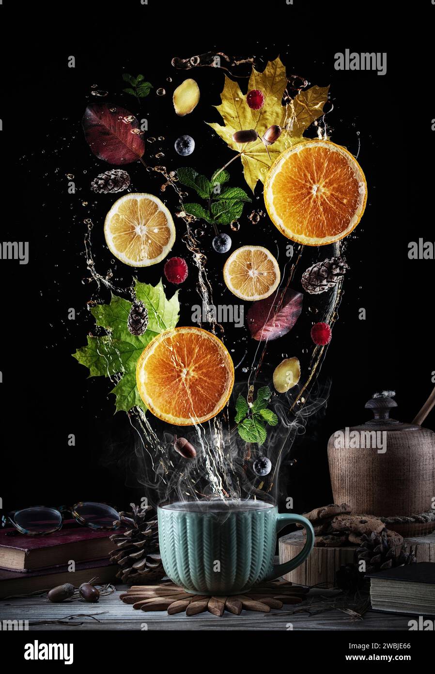 Tea splash composition on a black background. Slices of lemon, orange ...