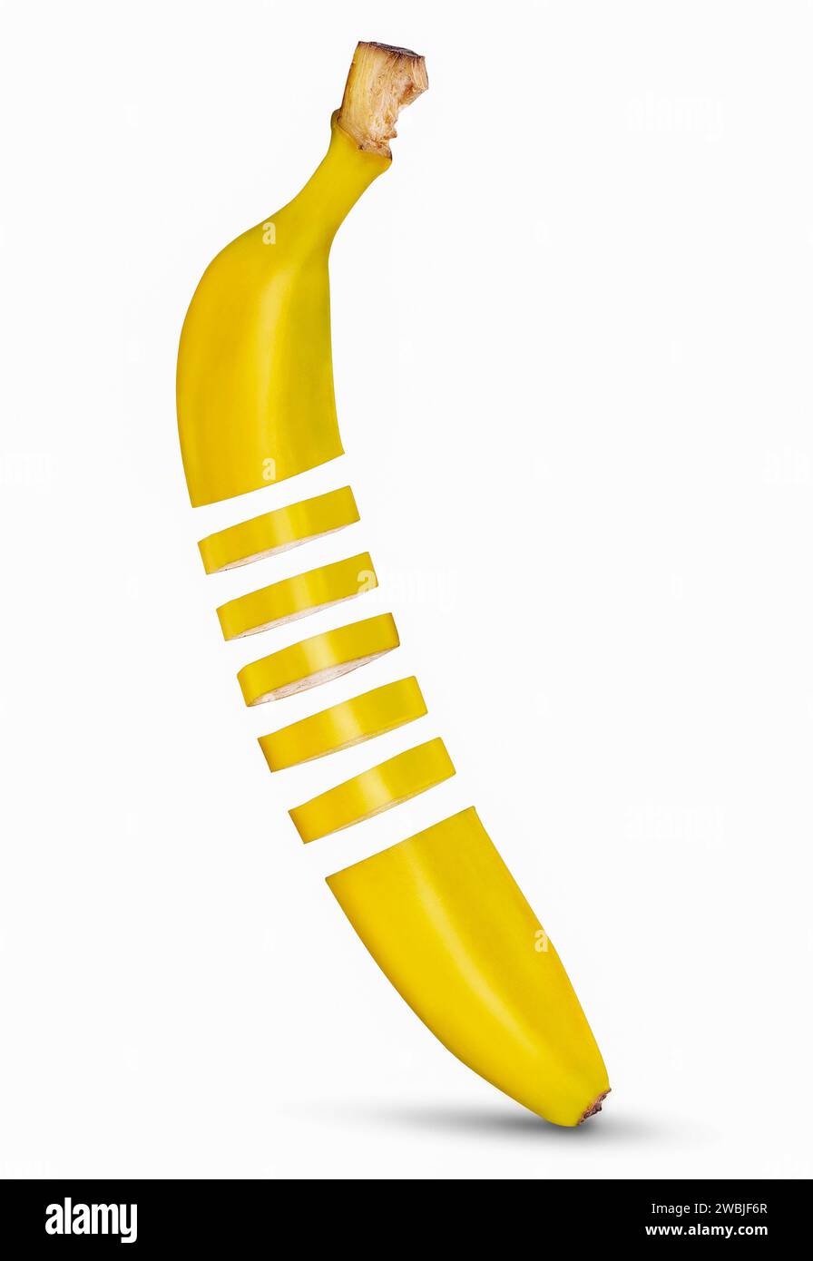 Big yellow banana sliced in pieces flying in the air. Isolated on white ...