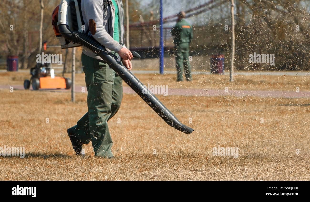 Blower removes fallen leaves hi-res stock photography and images - Alamy