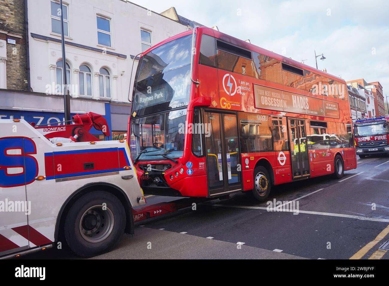 London, UK. 11 January 2024. . An electric bus is towed away after it ...