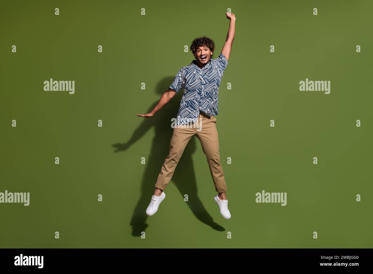 Full length photo of cool lucky guy wear print shirt jumping high ...