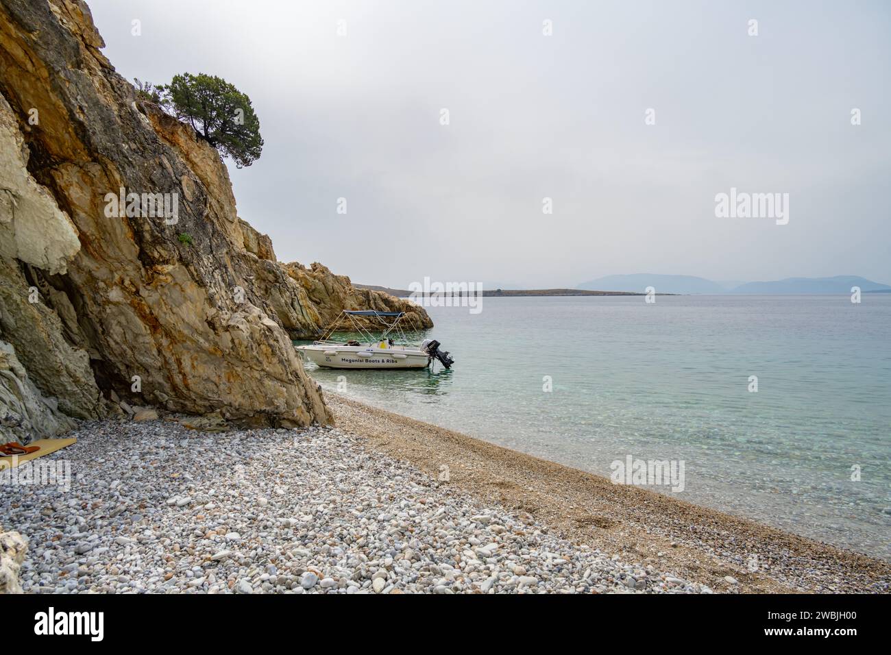 Speed boat moored on a rocky beach on the isle of Meganisi Greece Stock ...