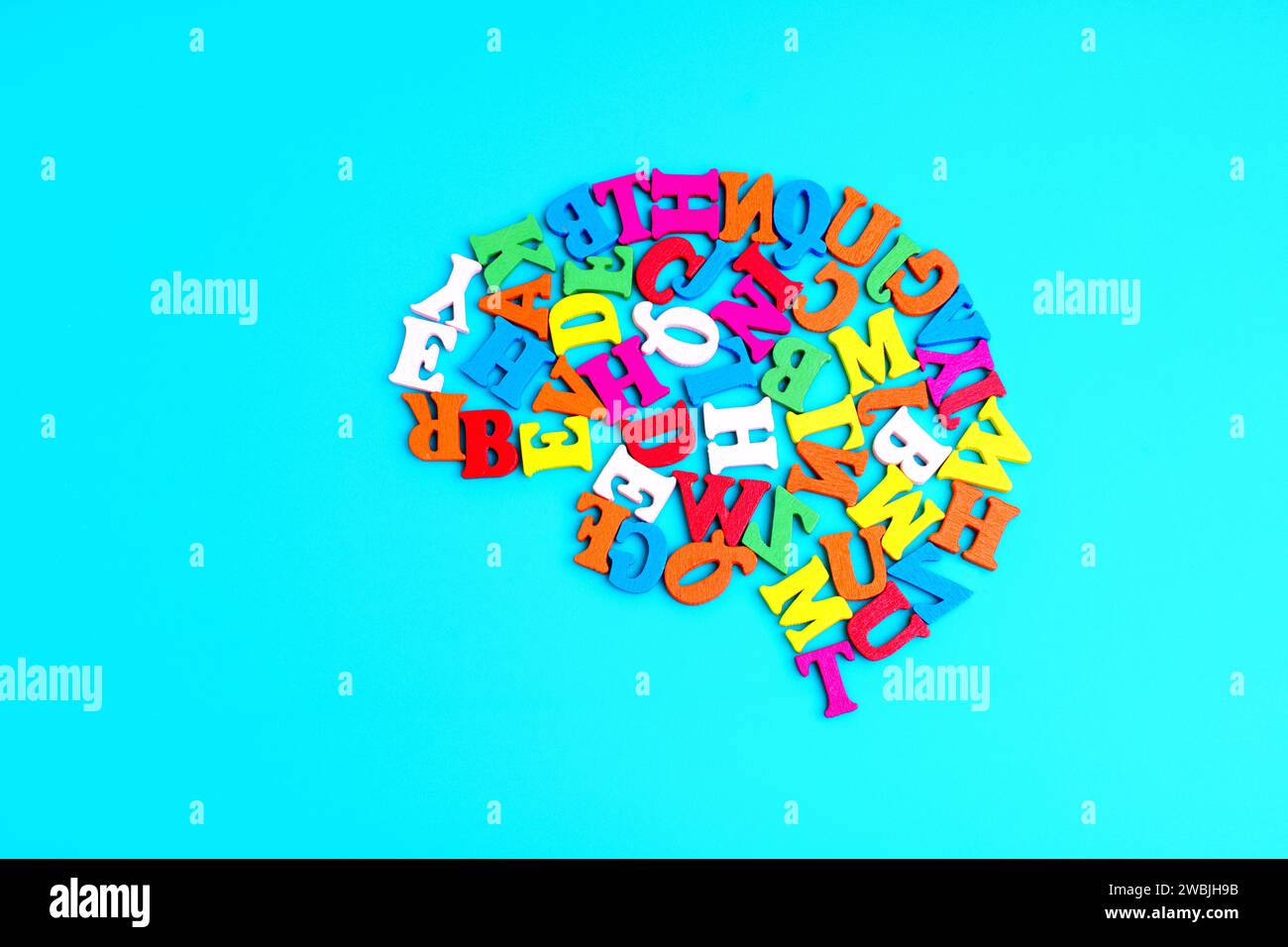 Human brain shape made from colorful wooden letters, arranged on a ...