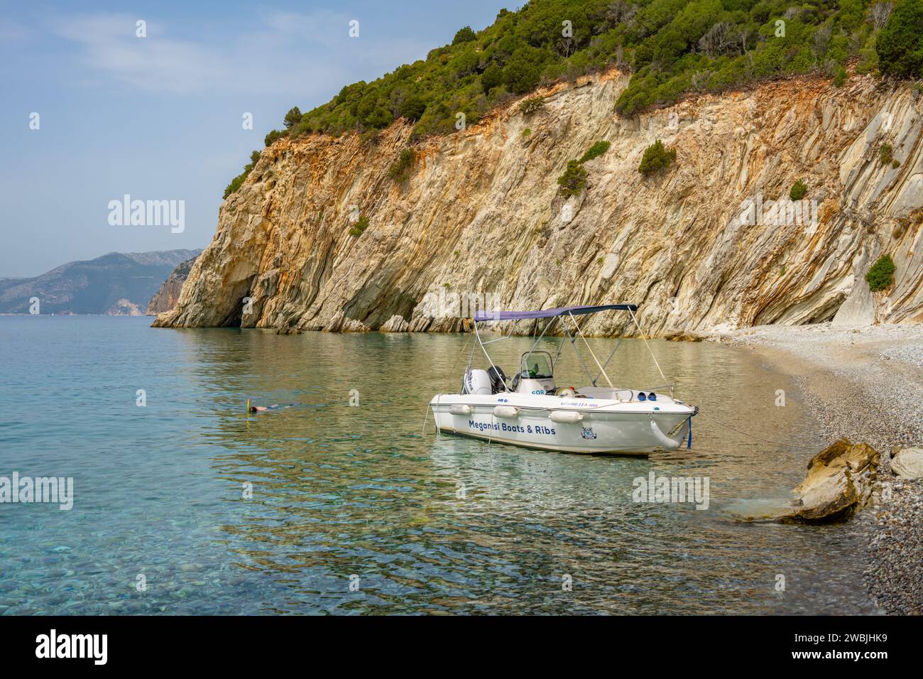 Speed boat moored on a rocky beach on the isle of Meganisi Greece Stock ...