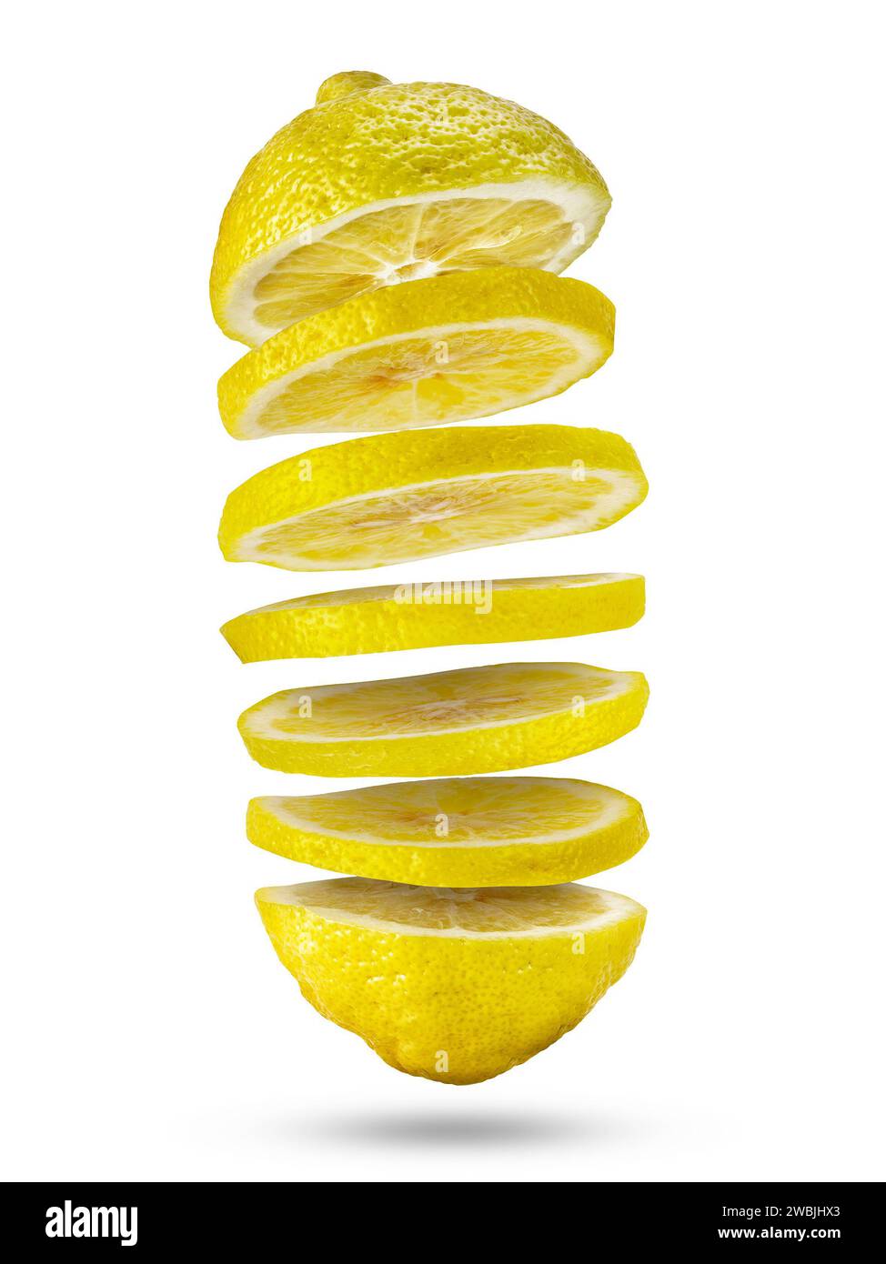 Sliced pieces of yellow fresh lemon flying in the air isolated on white ...