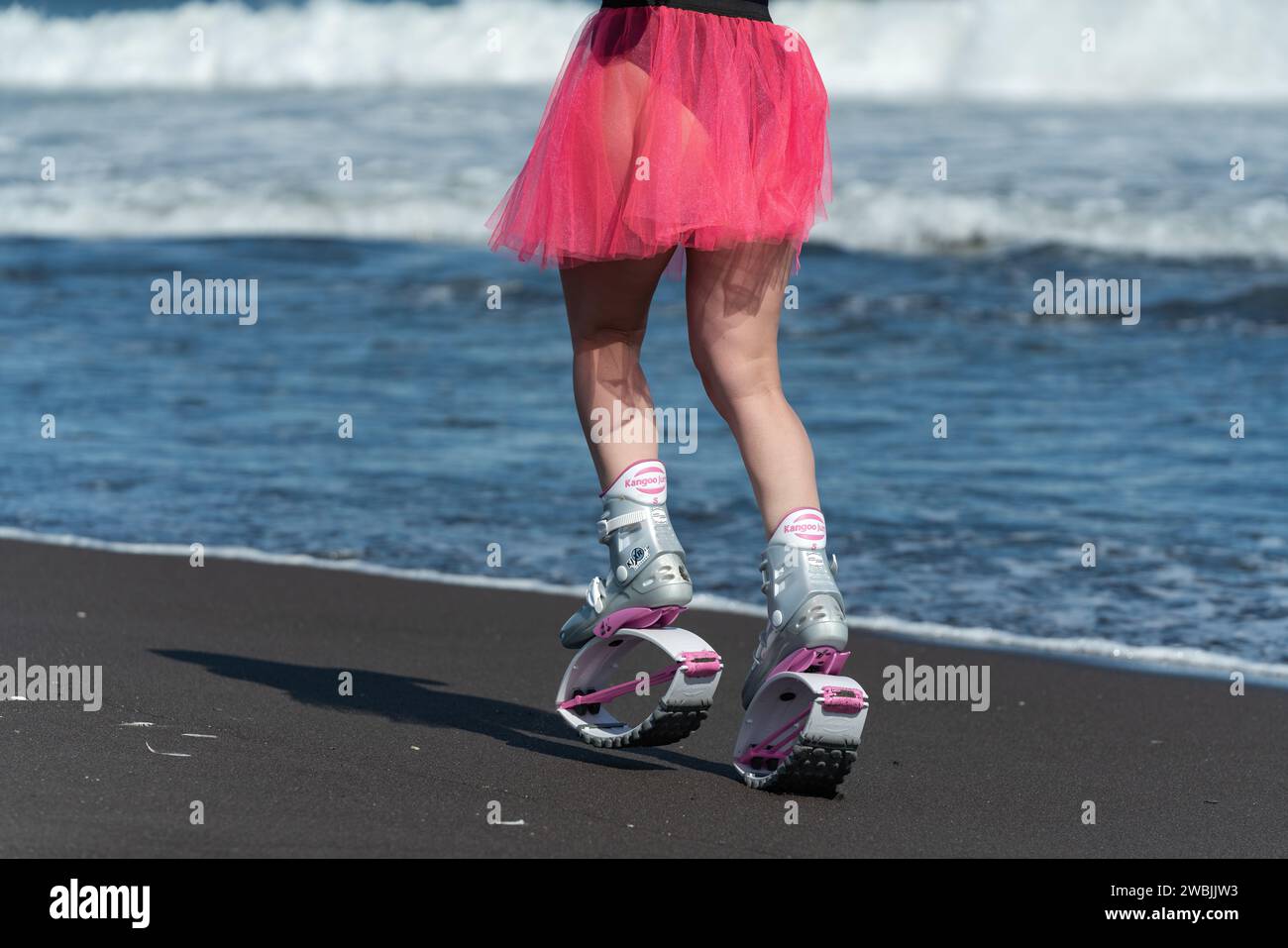 Sporty woman legs in Kangoo Jumps sports boots, black swimsuit and ...