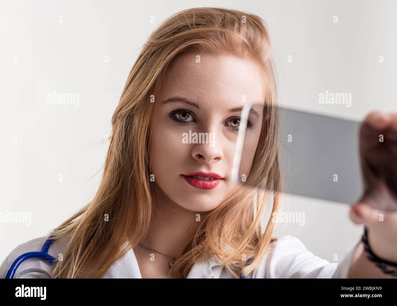 Confident medic with transparent smartphone looks to the future of ...