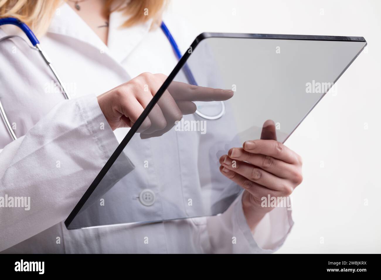 Healthcare professional demonstrates a clear tablet, symbolizing ...