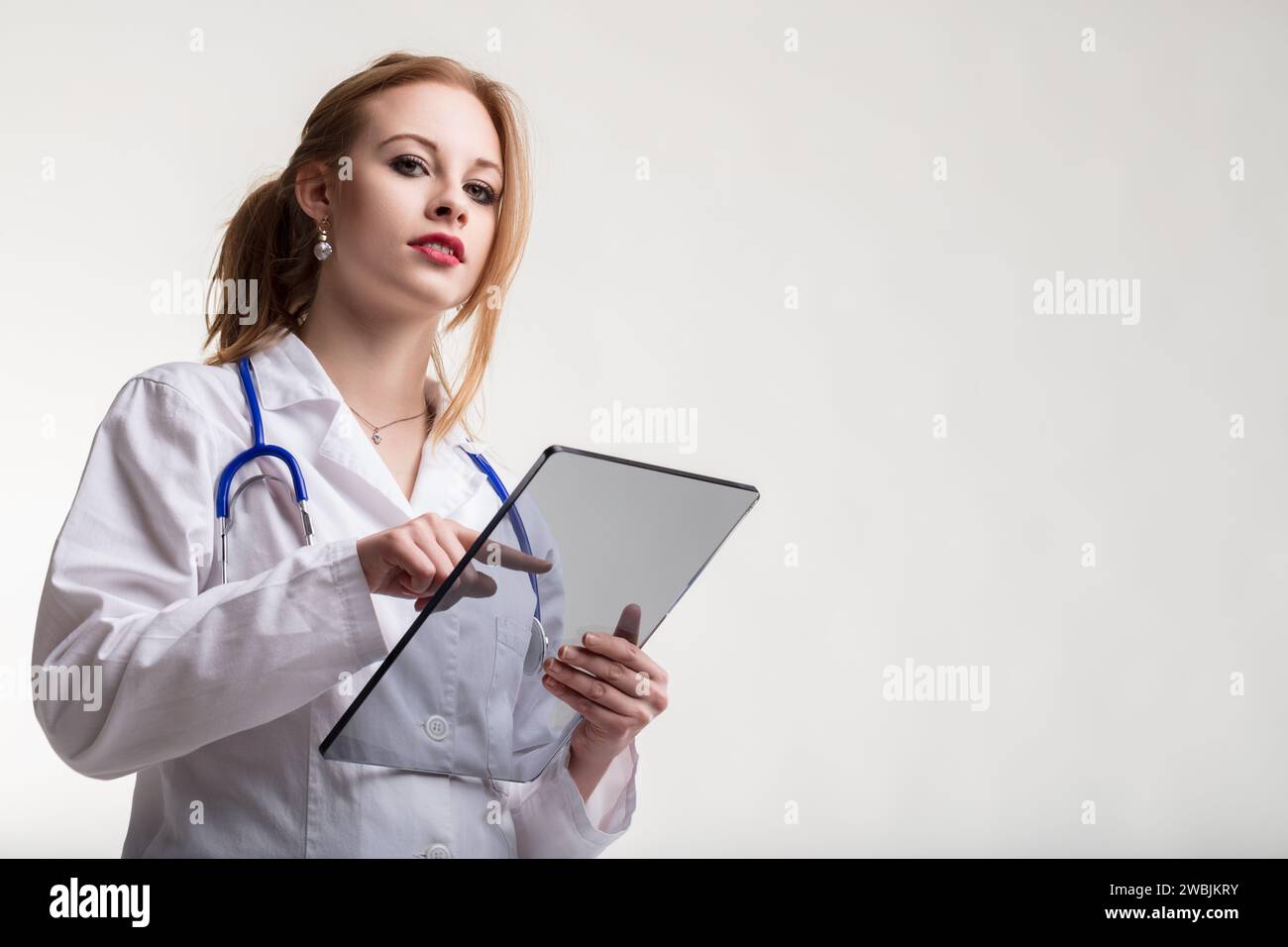 Radiant doctor with transparent tablet showcases the fusion of ...