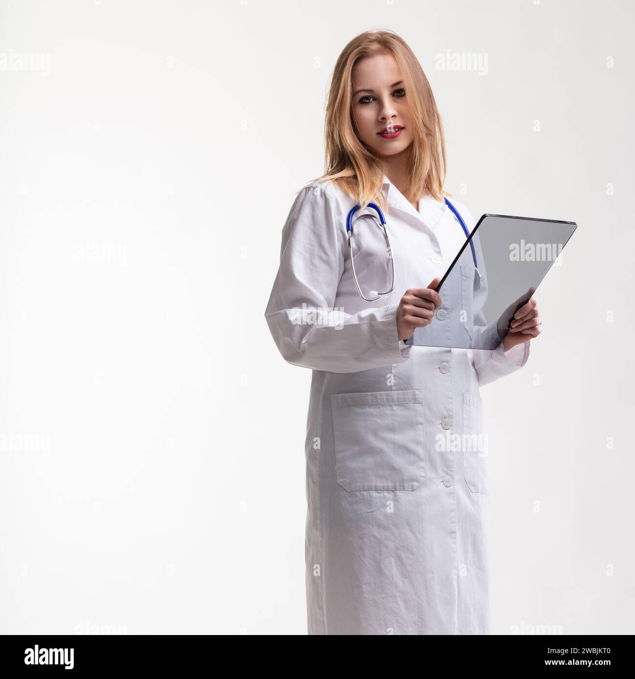Smiling confidently, this doctor with her transparent tablet is ready ...