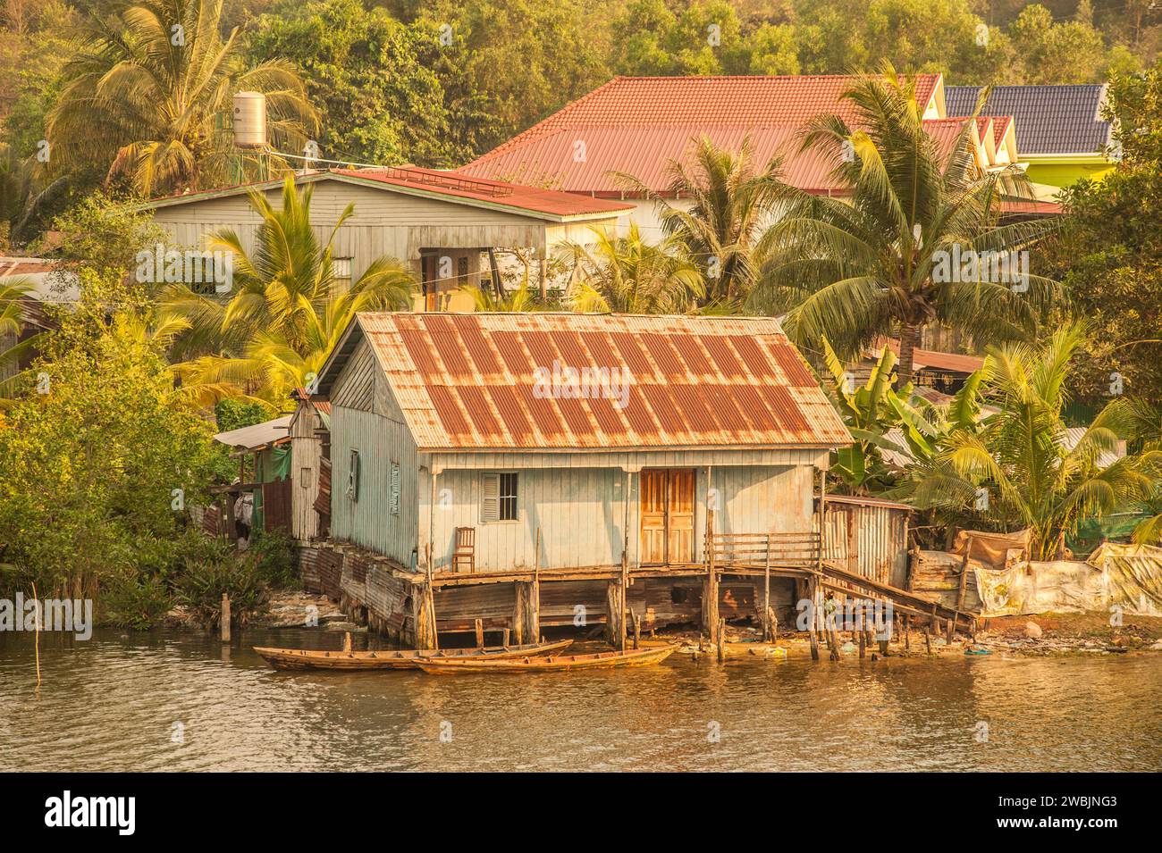 poverty-stricken house on stilts on the bank of a river during the dry ...