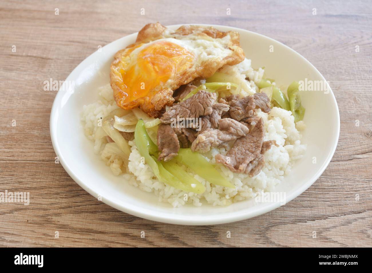 spicy stir fried slice beef meat with long sweet chili and onion on ...