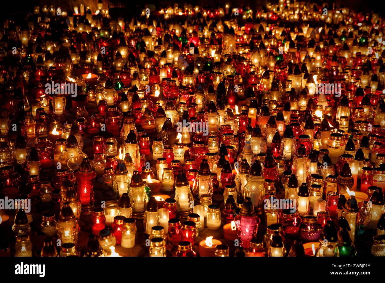 A sea of colorful candles light up the night in this beautiful image. A ...