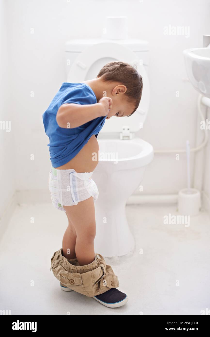 Boy child, potty training and toilet with thinking, diaper and pants on ...
