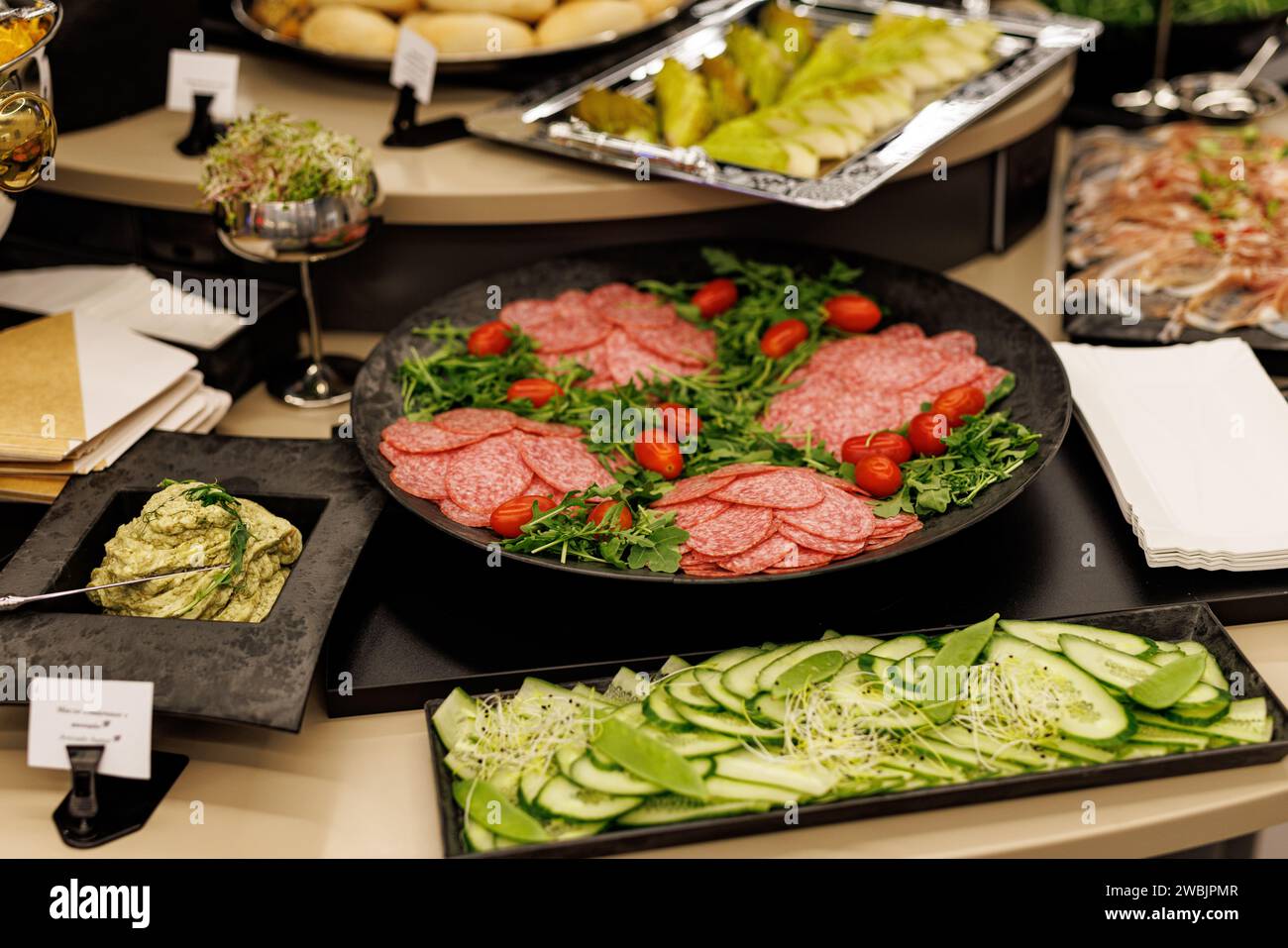 A photo of a buffet table with various dishes and platters of food ...