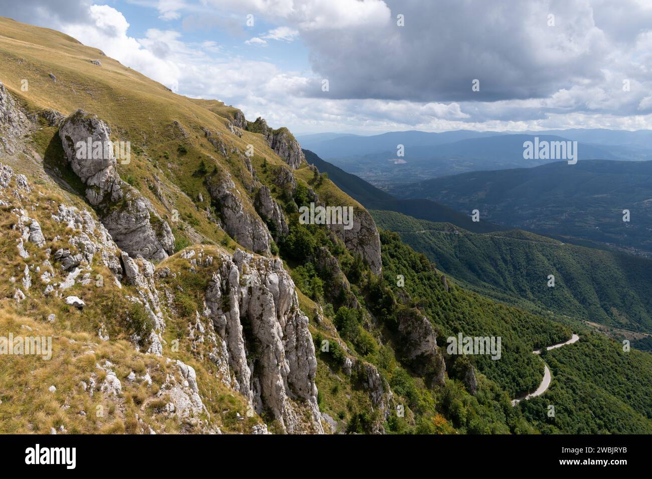 Rocky cliff on Vlasic mountain against valley with villages during ...