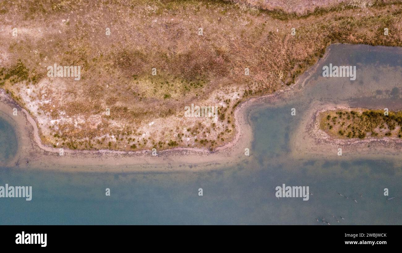This is an aerial shot capturing the intricate curves of a serpentine ...
