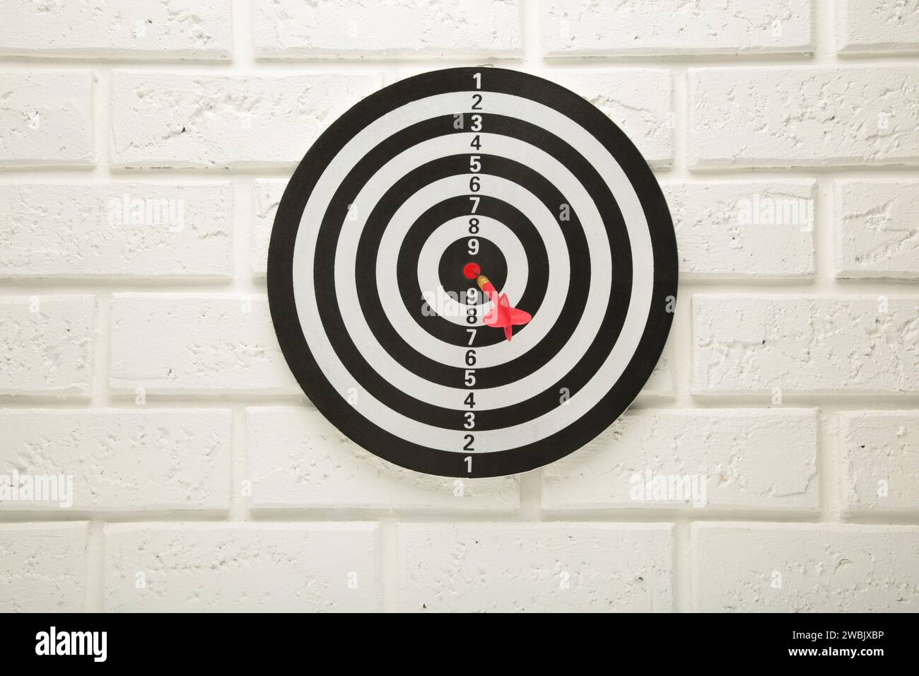Darts Board on the white wall background. Top view Stock Photo - Alamy