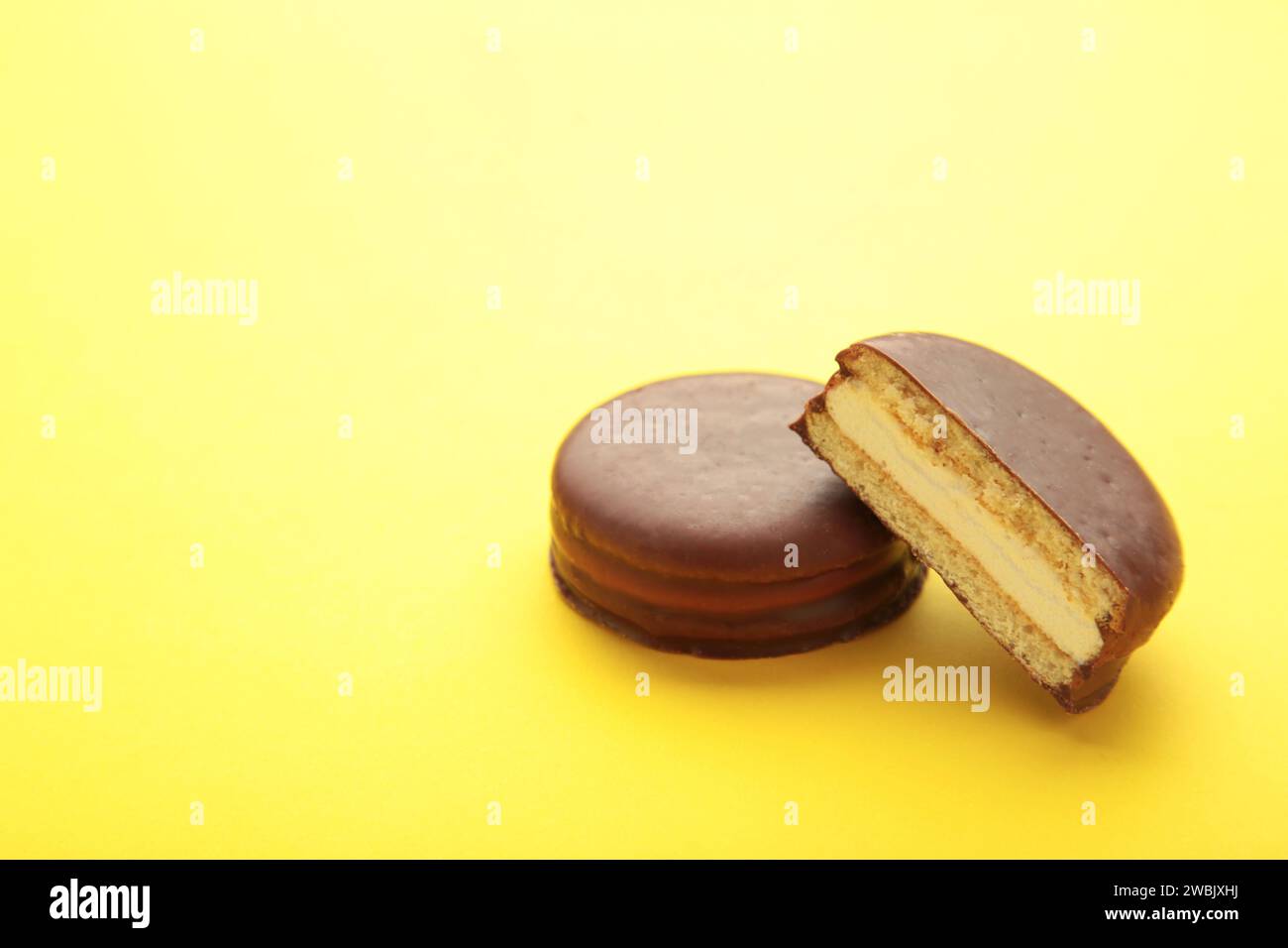 Choco pie chocolate coated snacks on yellow background. Top view Stock ...