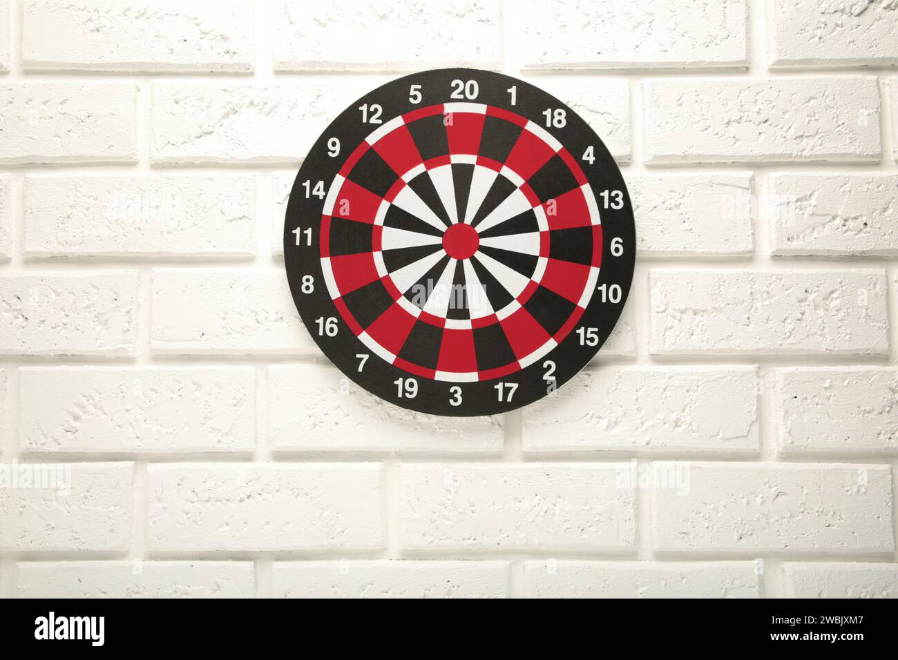 Darts Board on the white wall background. Top view Stock Photo - Alamy