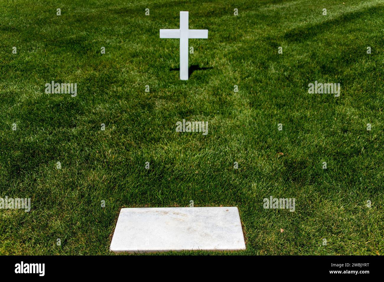 White marble tomb and cross at Arlington National Cemetery, a military ...