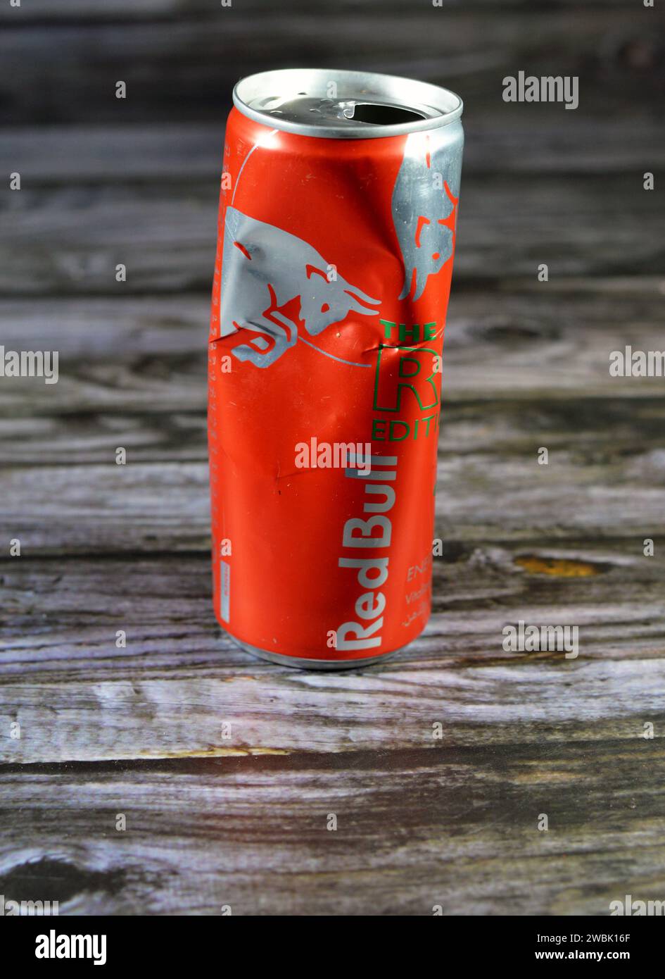 Cairo, Egypt, January 9 2024: Crushed dented Red Bull energy drink, a ...