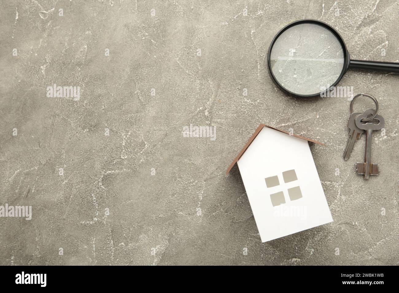 Paper house and key on grey background with copy space. Top view Stock ...