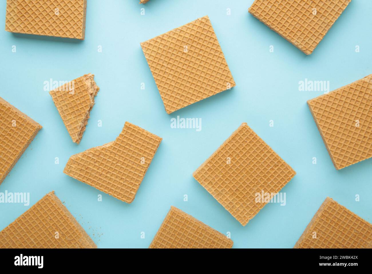 Square chocolate wafer biscuits on blue background. Top view Stock ...