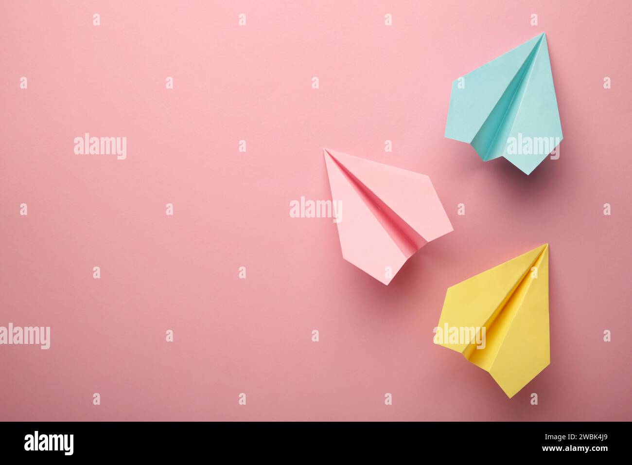 Color paper plane on pink background, Business competition concept. Top ...