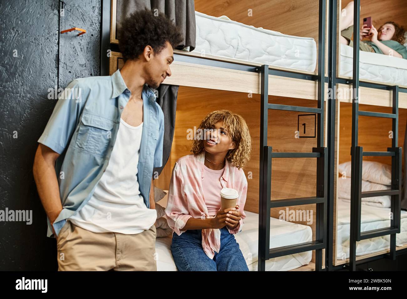Roommates talking in a hostel room hi-res stock photography and images ...