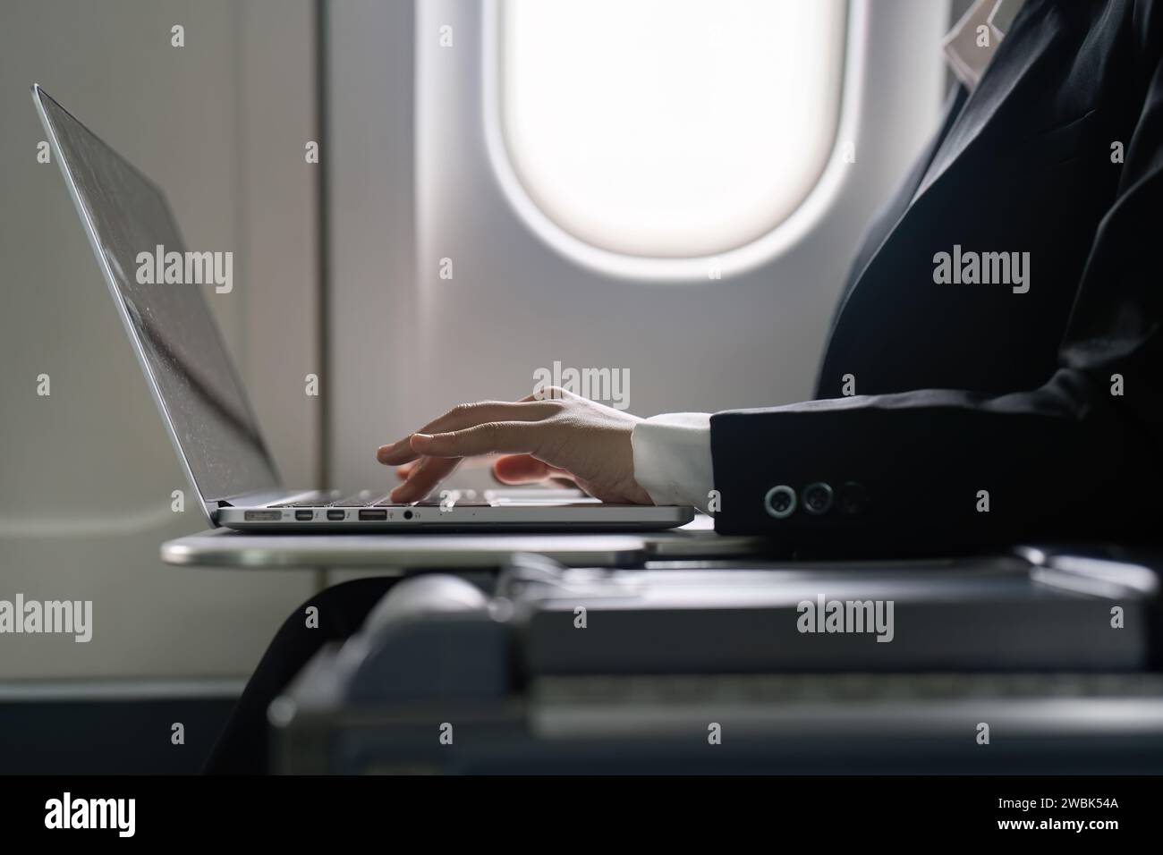 businesswoman flying and working in an airplane in first class, sitting ...