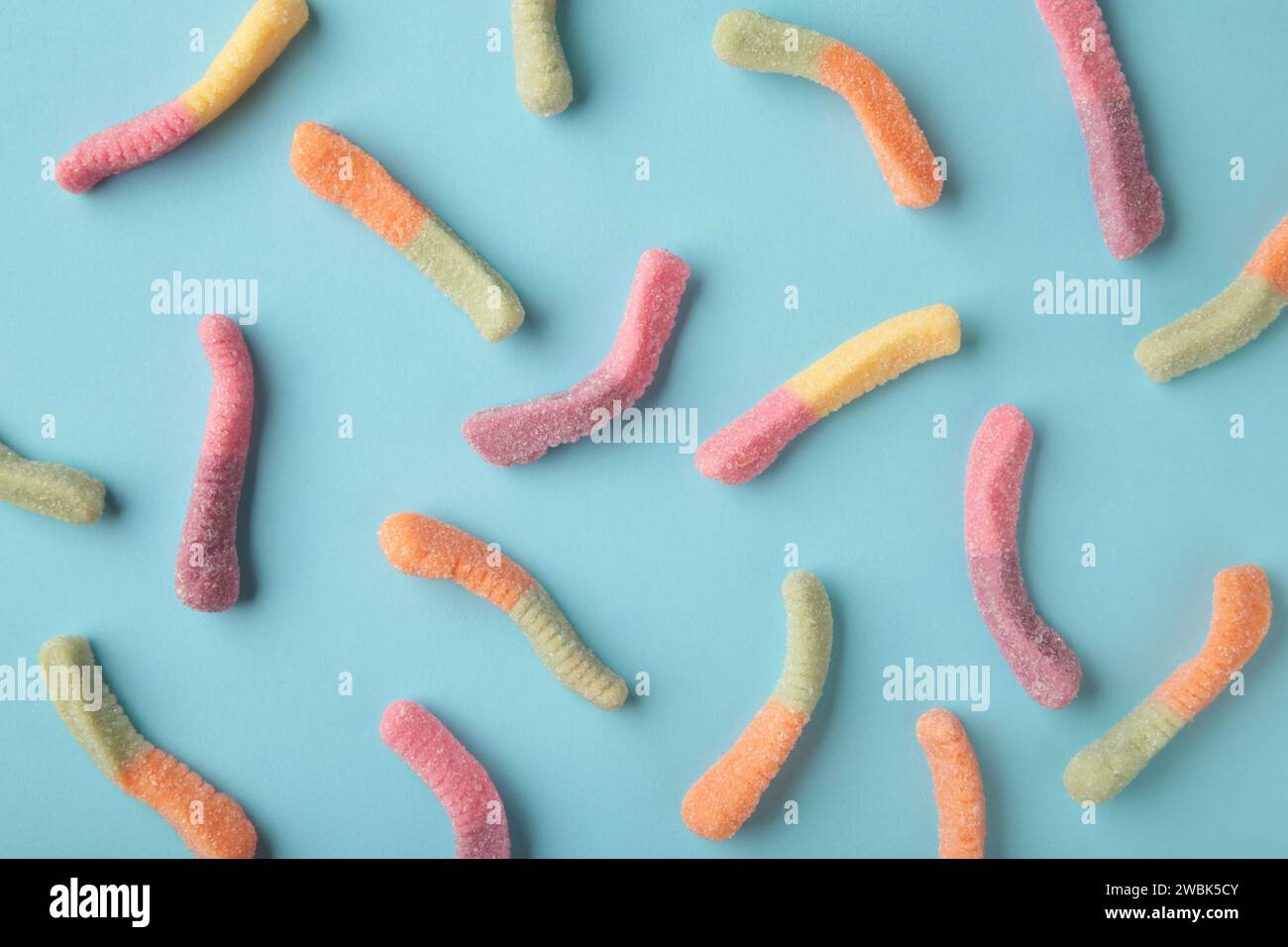 Top view of colorful gummy jelly worm candies on blue background Stock ...