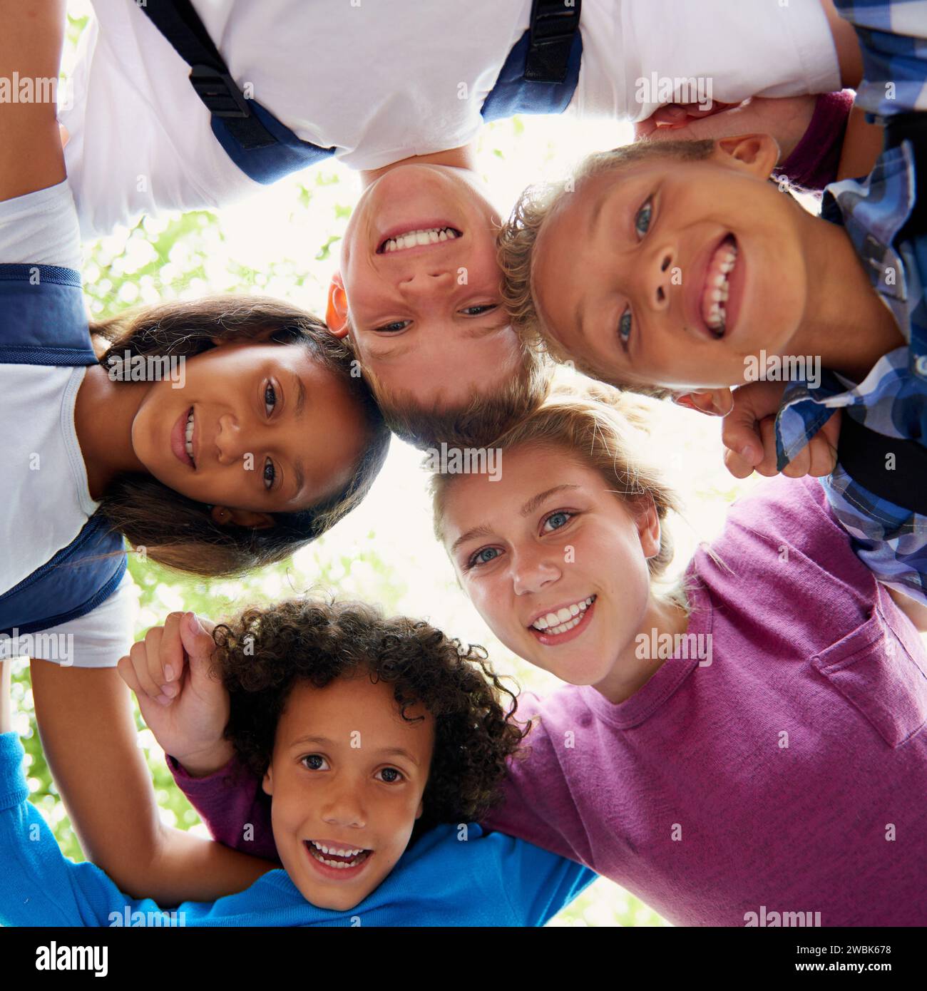 Children, woman and huddle in happy portrait, trees and sunshine with ...