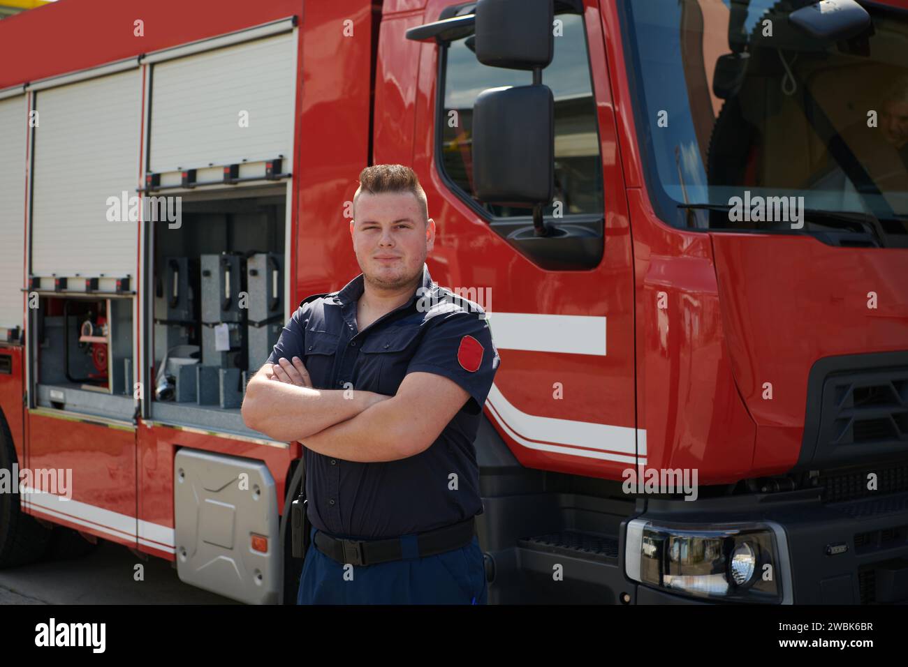 Confident firefighter stands with crossed arms, exuding resilience and ...