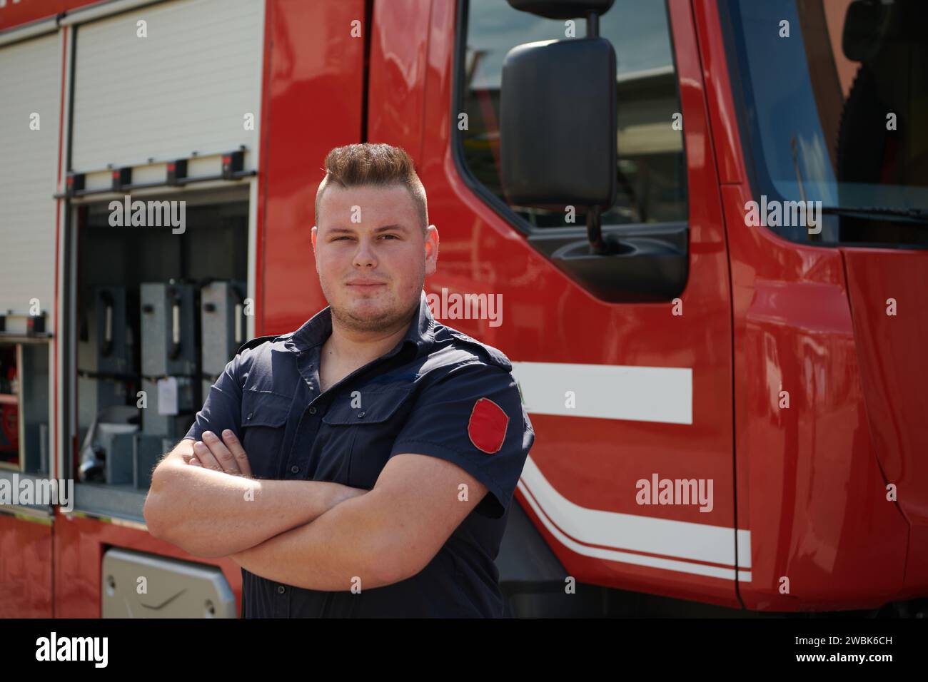 Confident firefighter stands with crossed arms, exuding resilience and ...