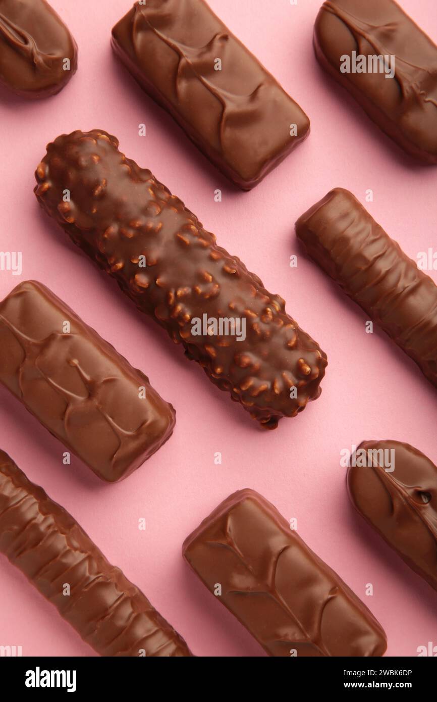 Mix of chocolate bars on pink background. Vertical photo Stock Photo ...