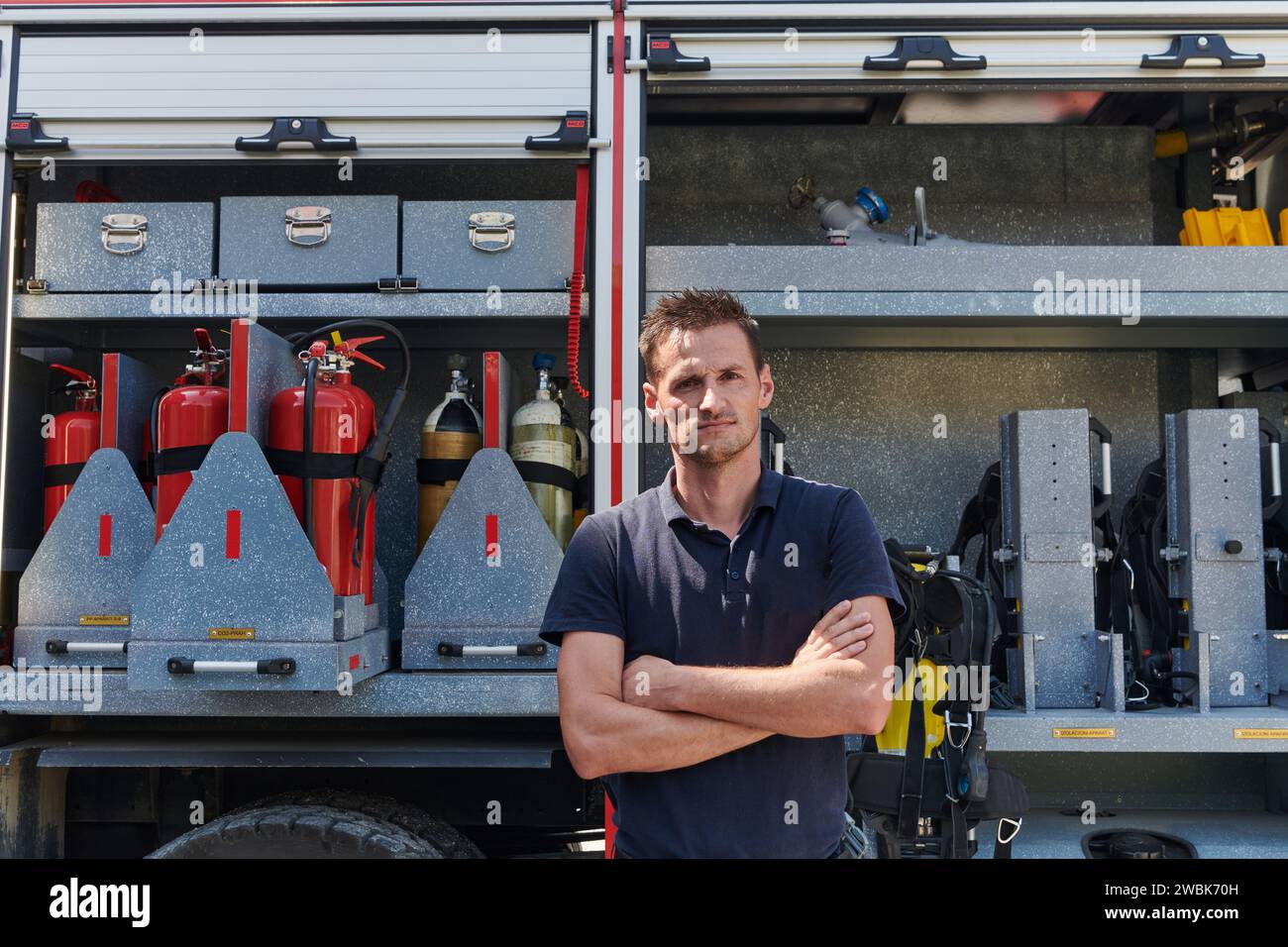 Confident firefighter stands with crossed arms, exuding resilience and ...