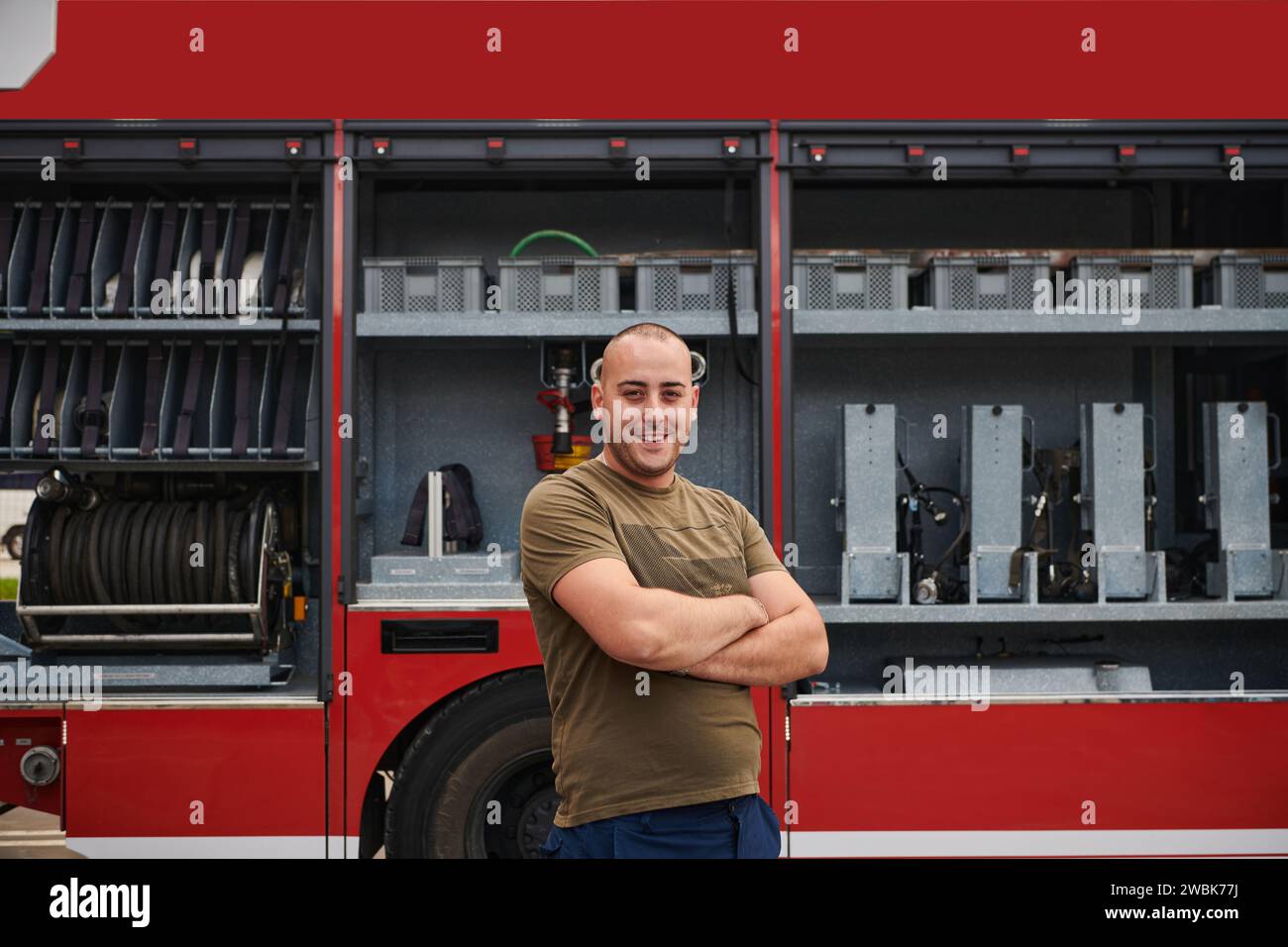 Confident firefighter stands with crossed arms, exuding resilience and ...