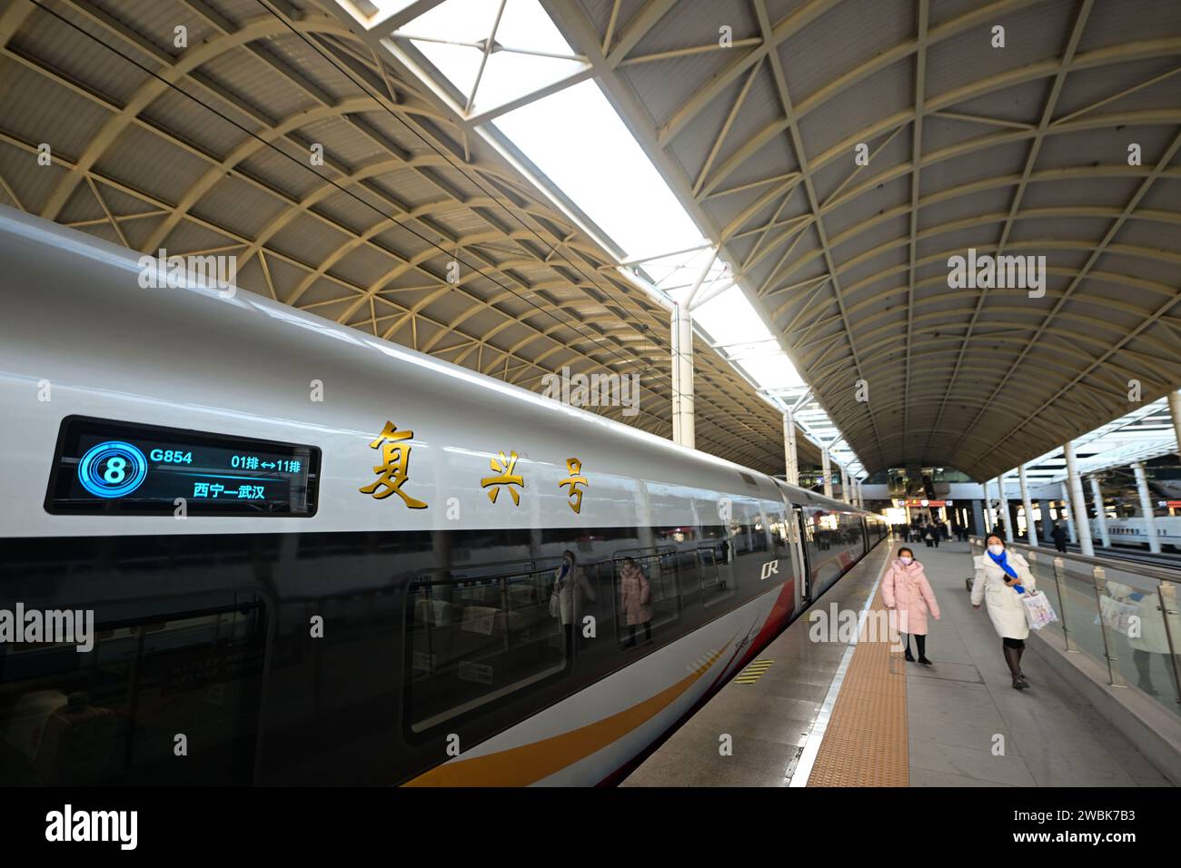 Xining, Jan. 11. 10th Jan, 2024. Passengers walk to board a Fuxing ...