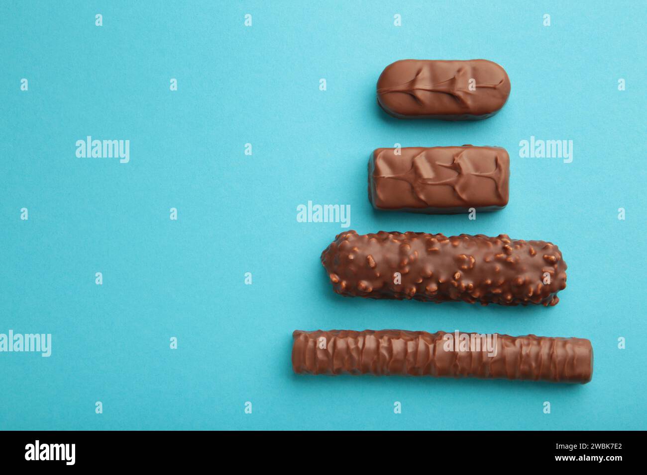 Mix of chocolate bars on blue background. Vertical photo Stock Photo ...